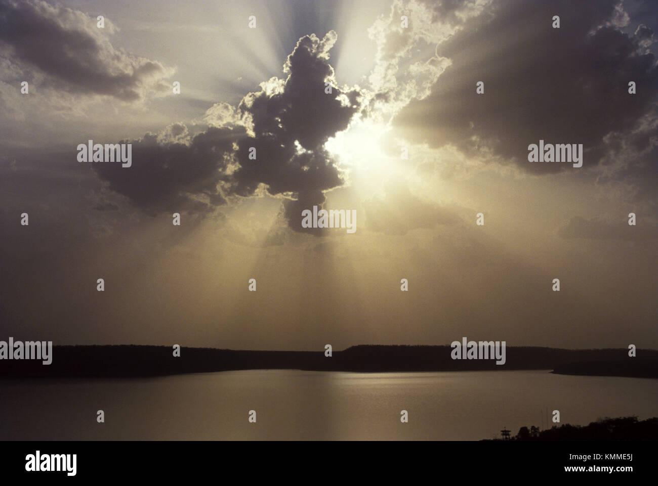 Bright sun rays from behind dark grey clouds Stock Photo - Alamy