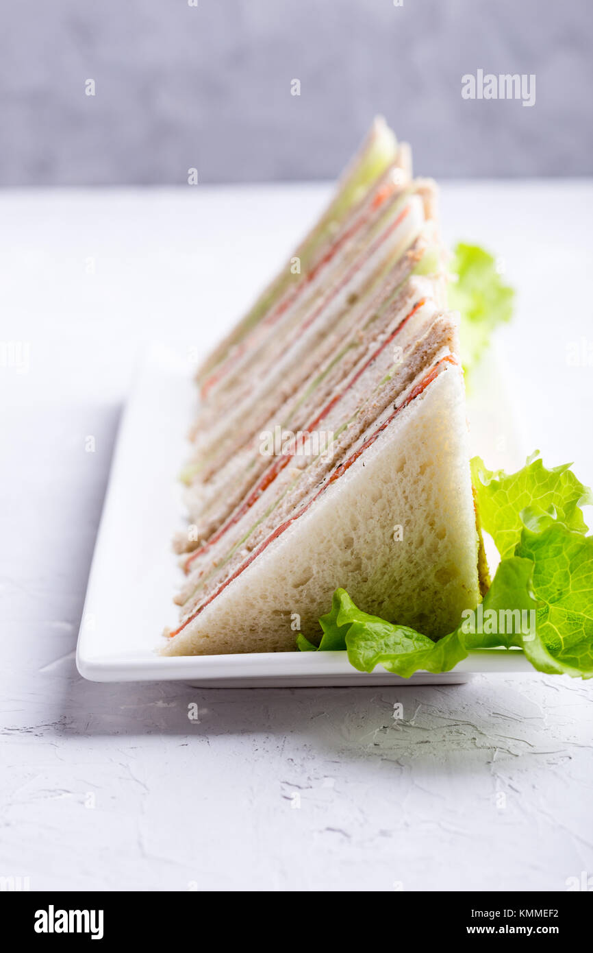 English tea sandwiches platter on white plate over light background ...