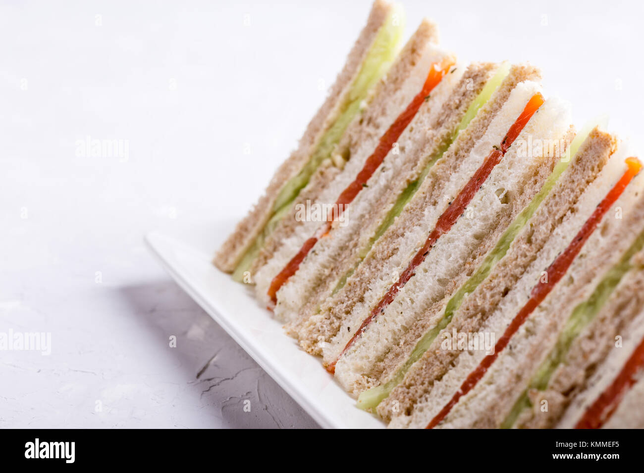 English tea sandwiches platter on white plate over light background ...