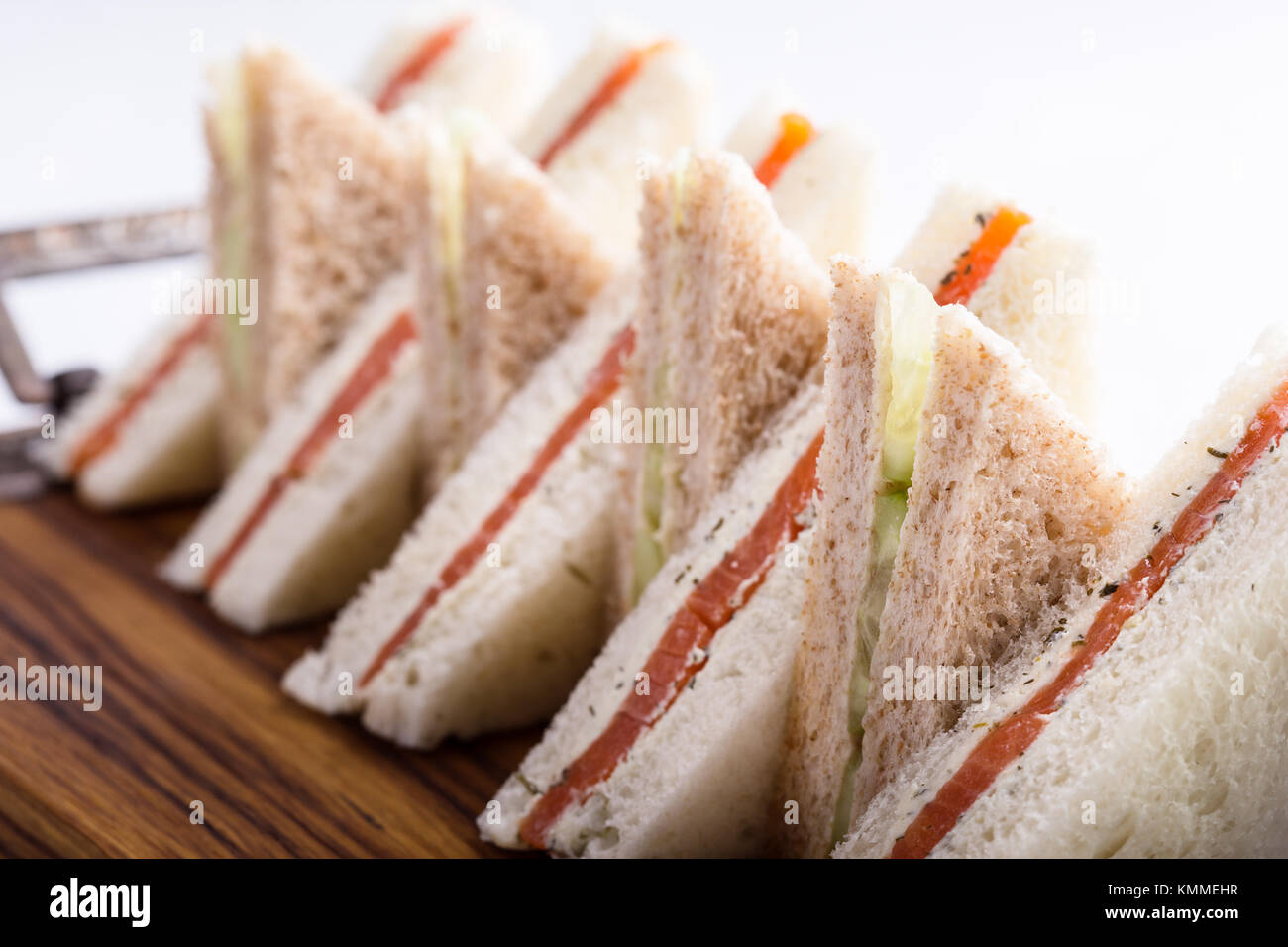 English tea sandwiches platter on wooden board over light background ...