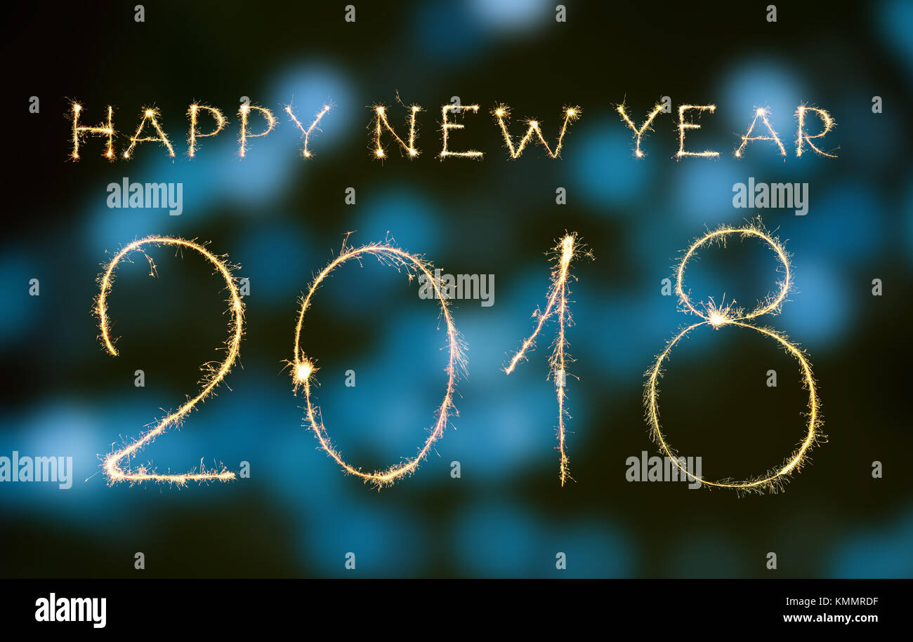 Happy new year and digits 2018 written with sparklers and bokeh ...