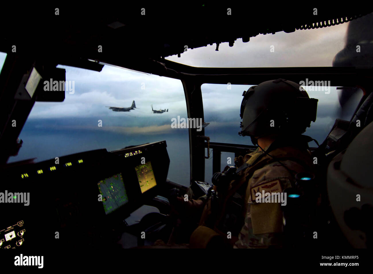 Air Force pilot of a CV-22 Osprey performing air to air refueling with ...