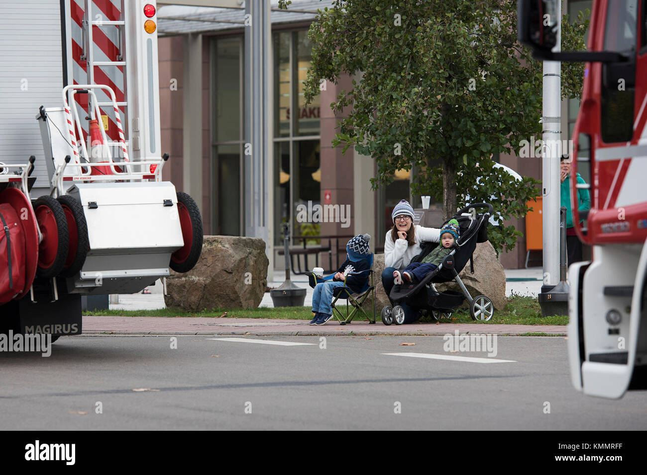 Members of the Kaiserslautern Military Community watch fire trucks pass ...