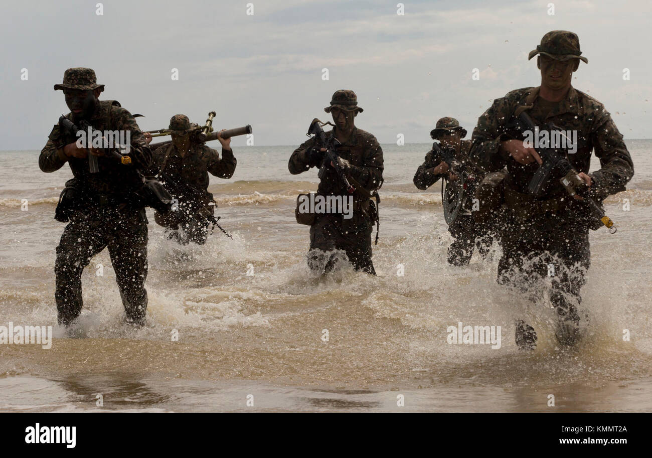 U.S. Marines and soldiers in the Malaysian Armed Forces storm the beach ...
