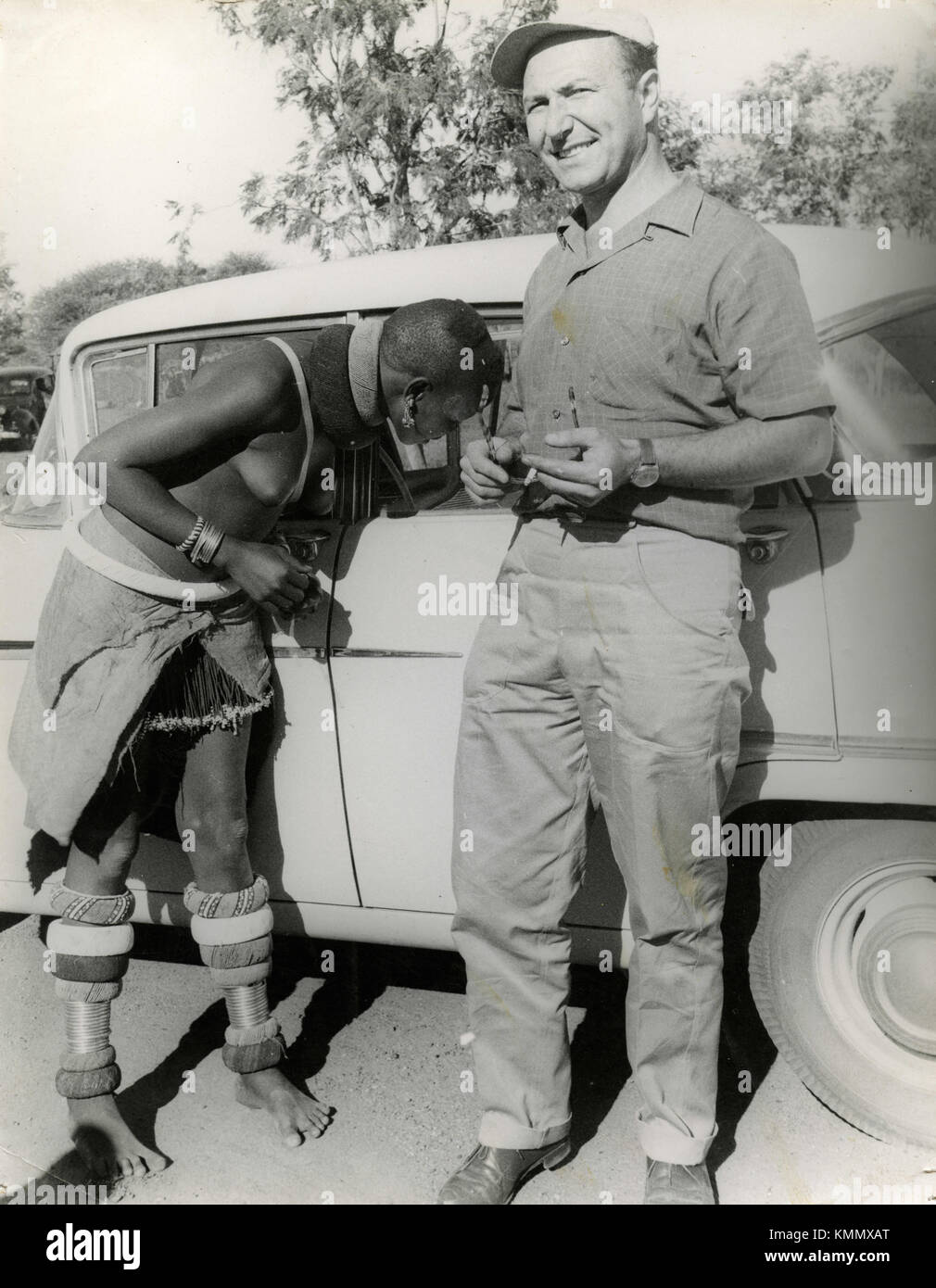 Local Woman Inspecting The Car Of The Foreigner Africa 1960s Stock