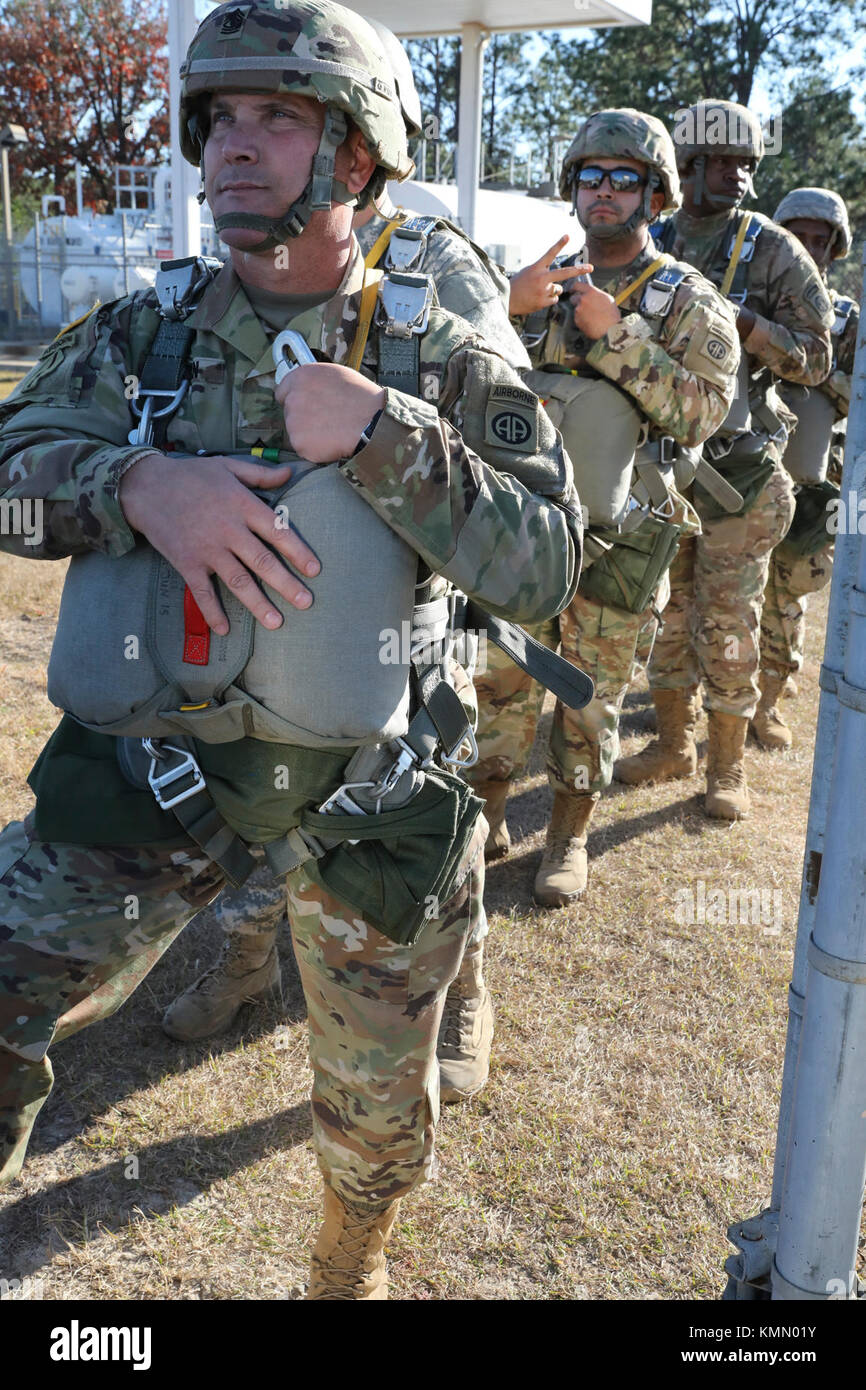 U.S. Army paratroopers wait to board a UH-60 Blackhawk helicopter ...