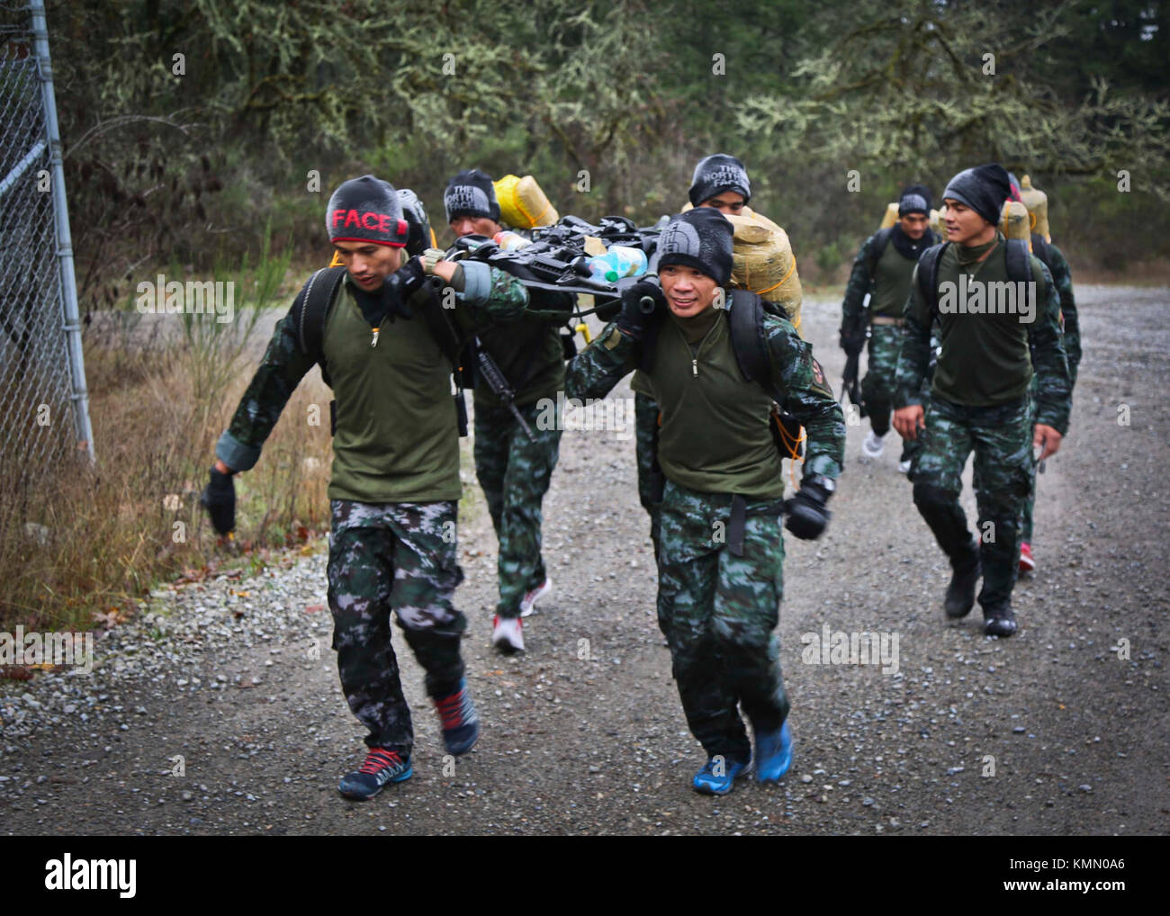 Members of the Philippine National Police participate in a timed ruck ...