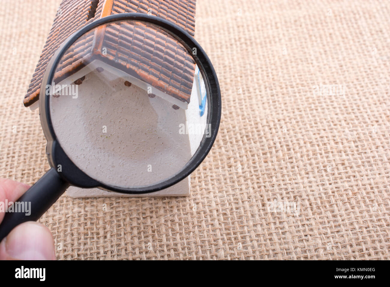 Little model house on behind a magnifying glass Stock Photo - Alamy