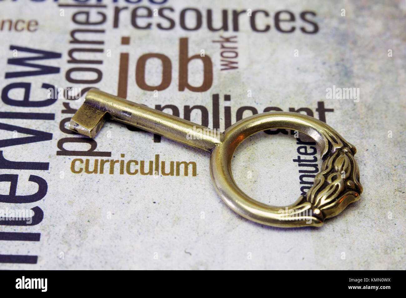 Golden key on job text Stock Photo - Alamy