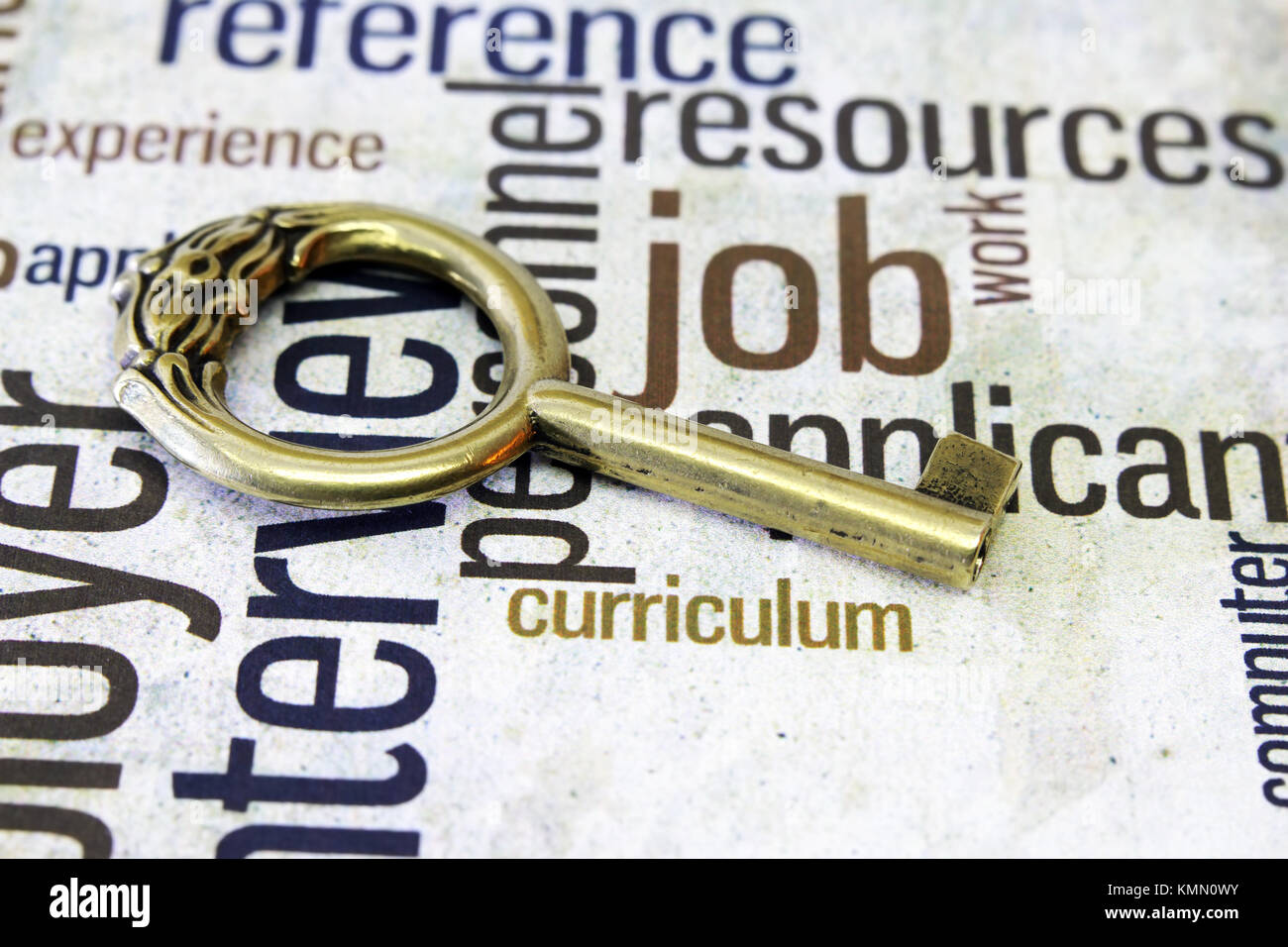 Golden key on job text Stock Photo - Alamy