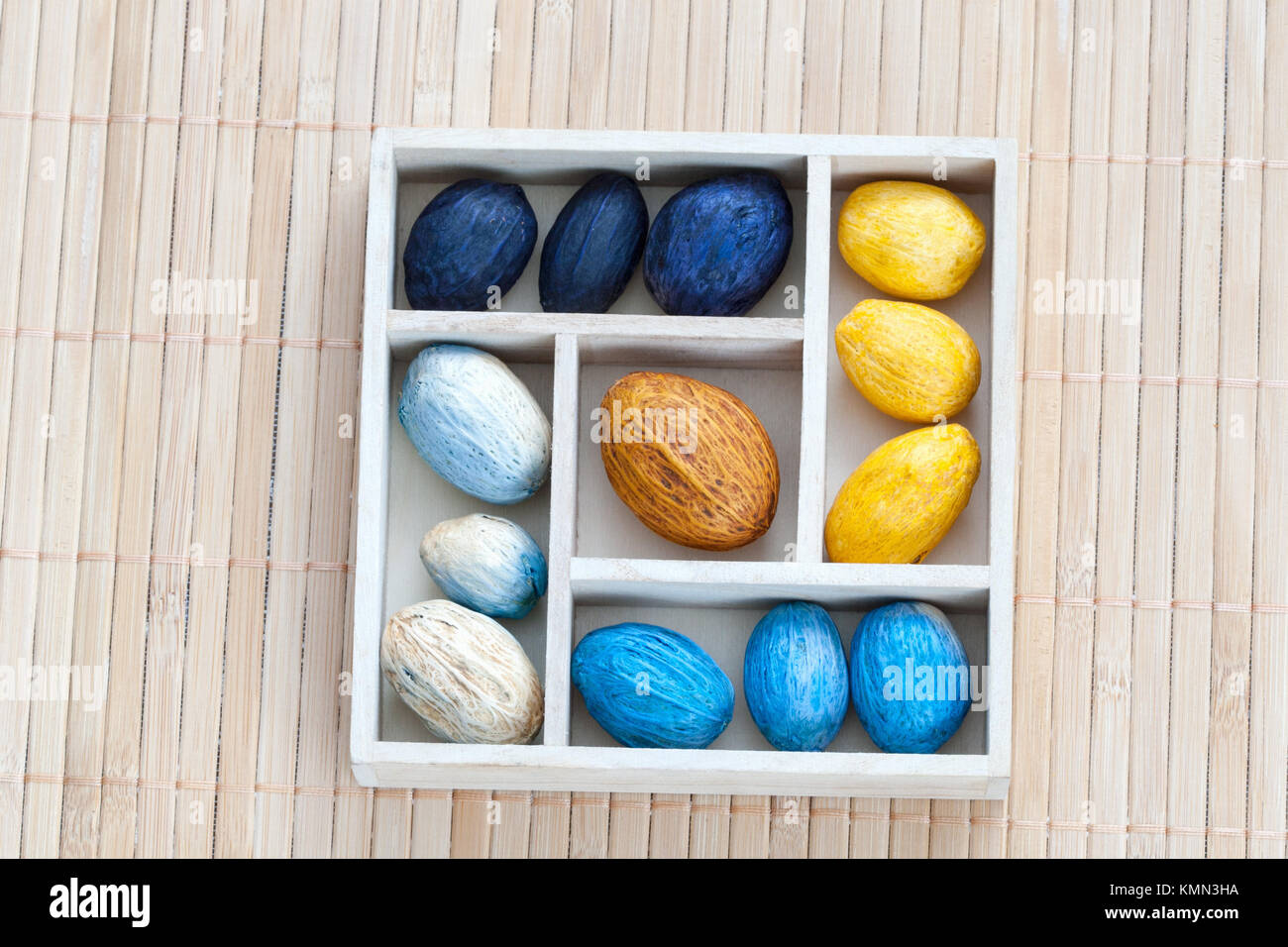 Box with colored nuts on a bamboo napkin Stock Photo - Alamy