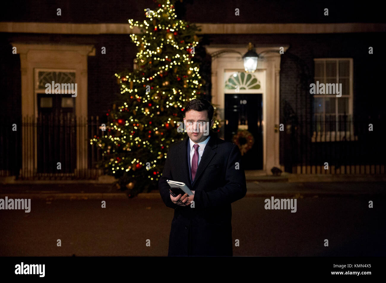 A TV reporter speaks to camera in Downing Street, London, as the ...