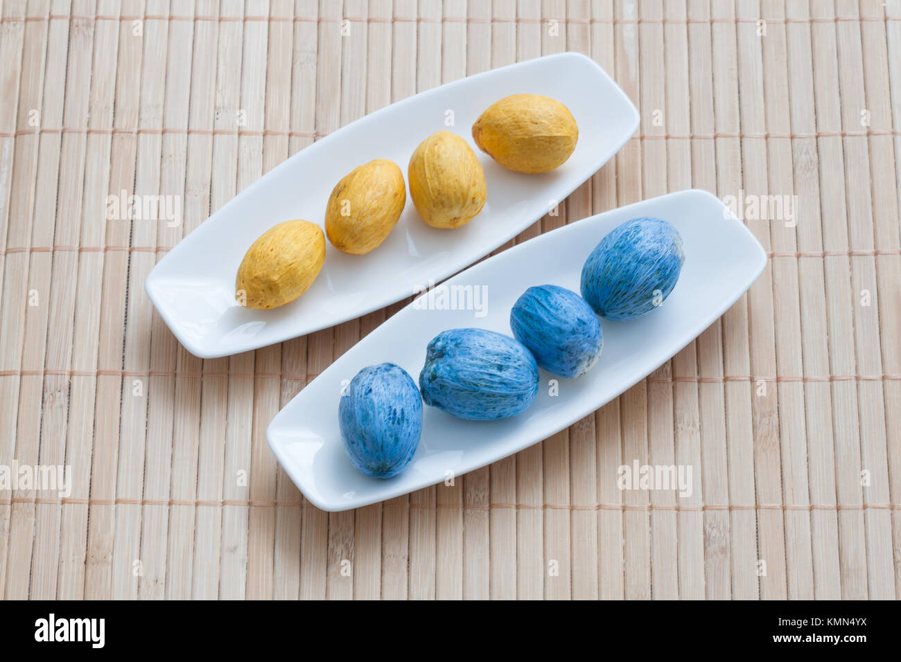 painted yellow and blue nuts on plates Stock Photo - Alamy