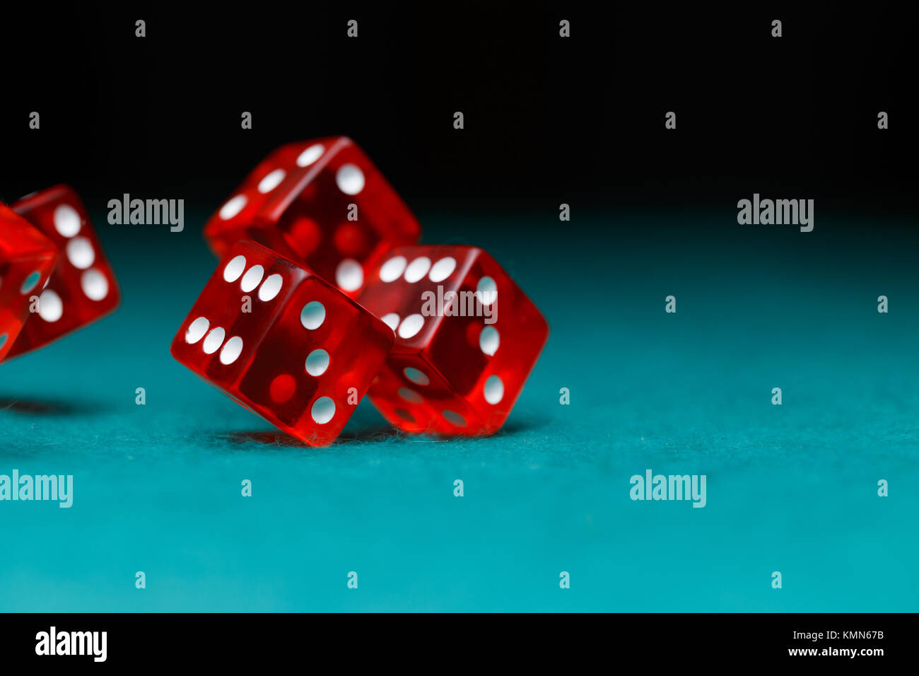 Photo of several red dice falling on green table Stock Photo - Alamy