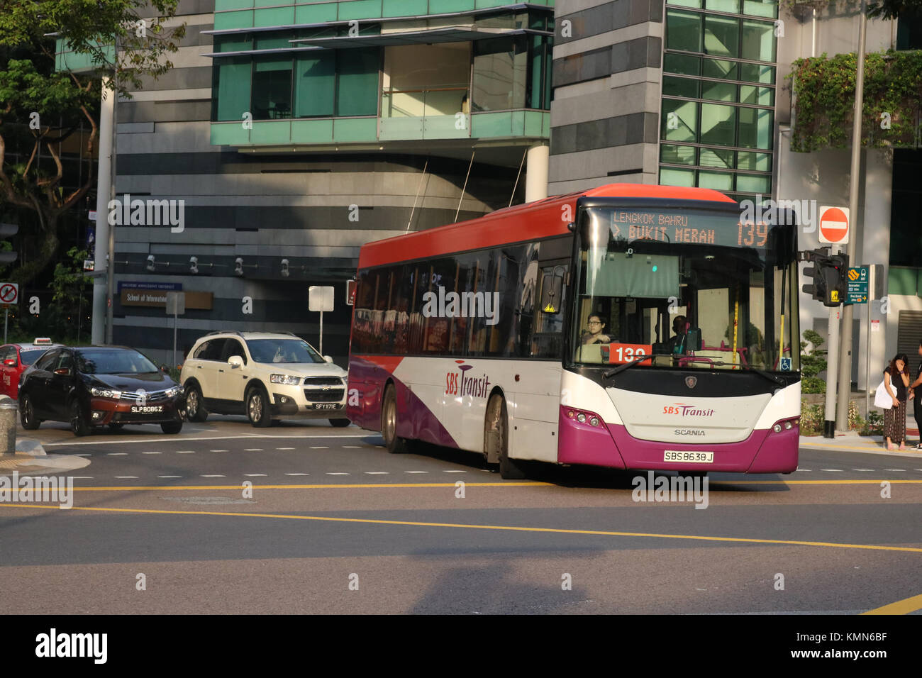 Single deck bus operated by SBS transit crossing a road intersection in ...