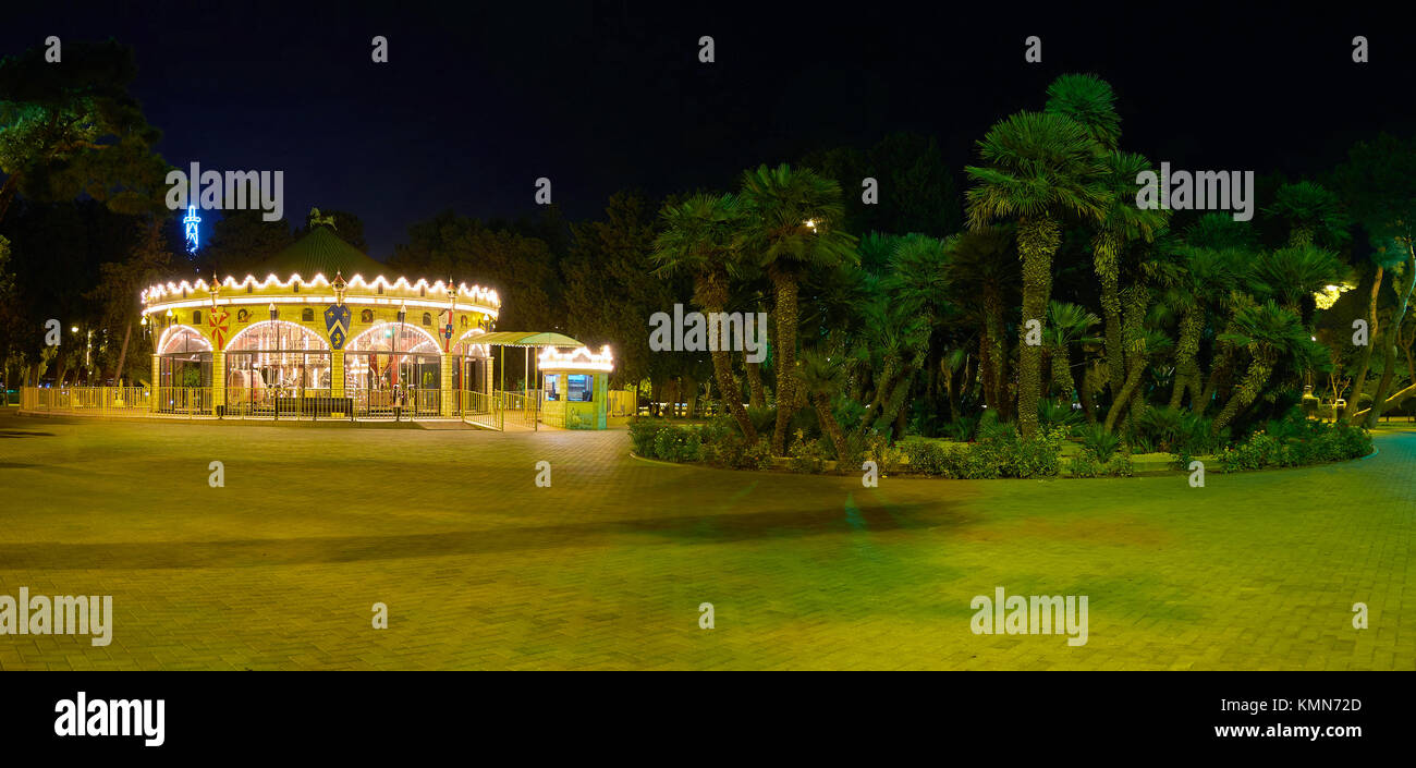 Panoramic view on promenade of Baku with lush greenery and illuminated ...