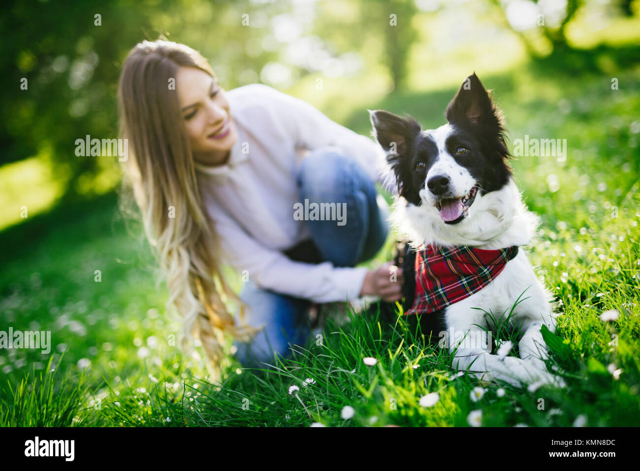 Beautiful woman walking cute dog in nature Stock Photo - Alamy