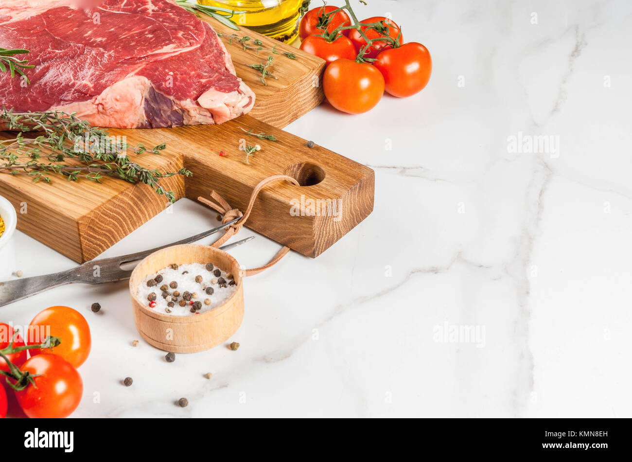 Fresh raw meat, lamb beef marble steak on a cutting board, with ...