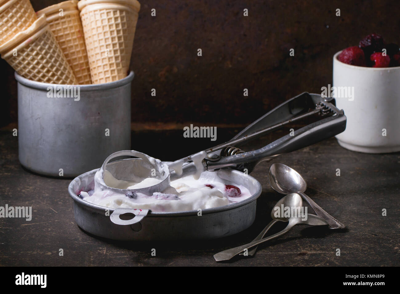 Aluminium plate with homemade melting vanilla ice cream, mug of frozen ...