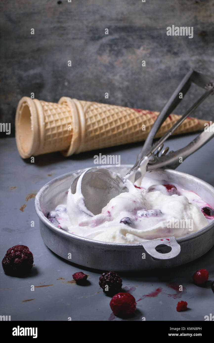 Aluminium plate with homemade vanilla ice cream, mix of frozen berries ...