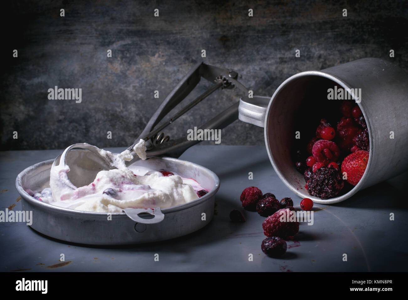Aluminium plate with vanilla ice cream and mix of frozen berries ...