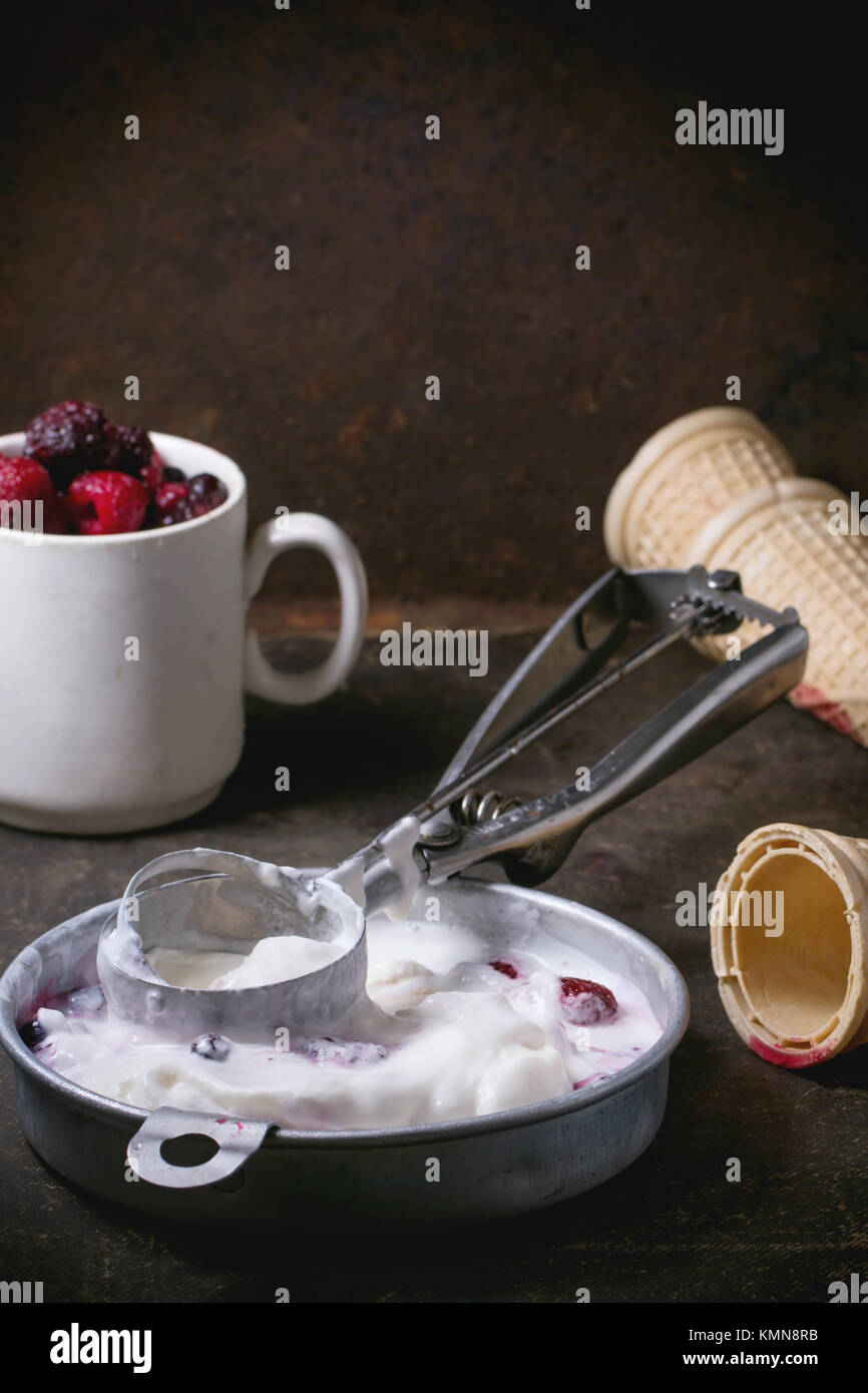 Aluminium plate with vanilla ice cream, mix of frozen berries and ...