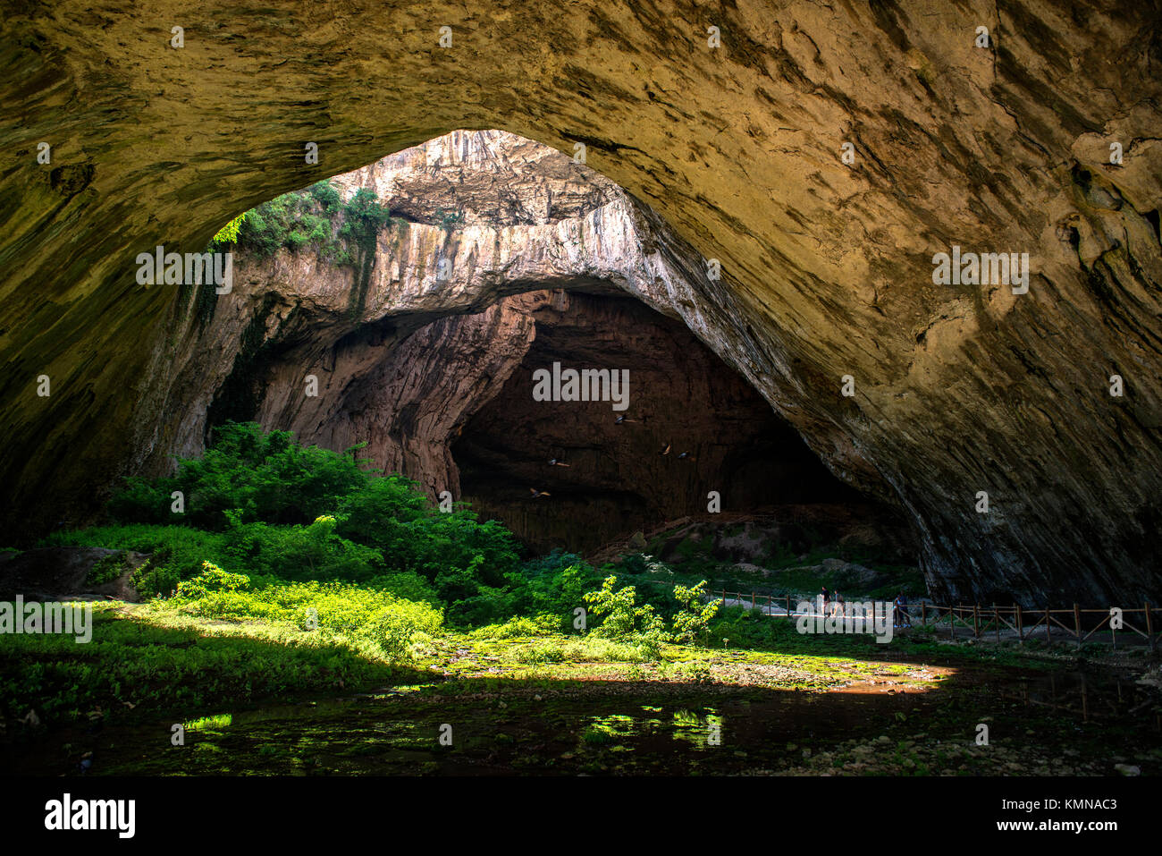 huge cave with holes on top and river inside Stock Photo - Alamy