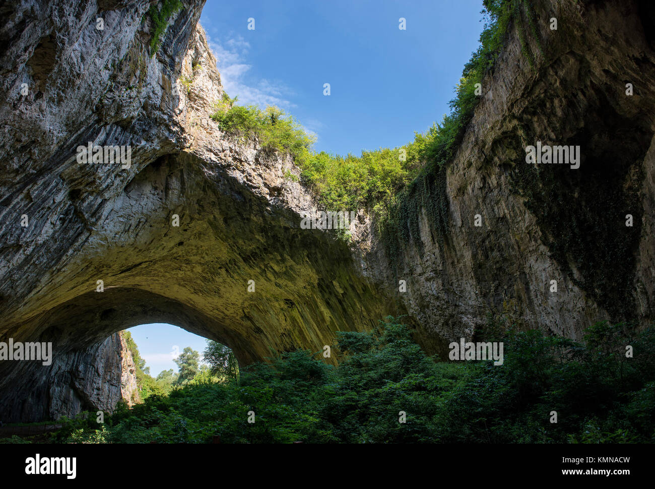 huge cave with holes on top and trees inside Stock Photo - Alamy