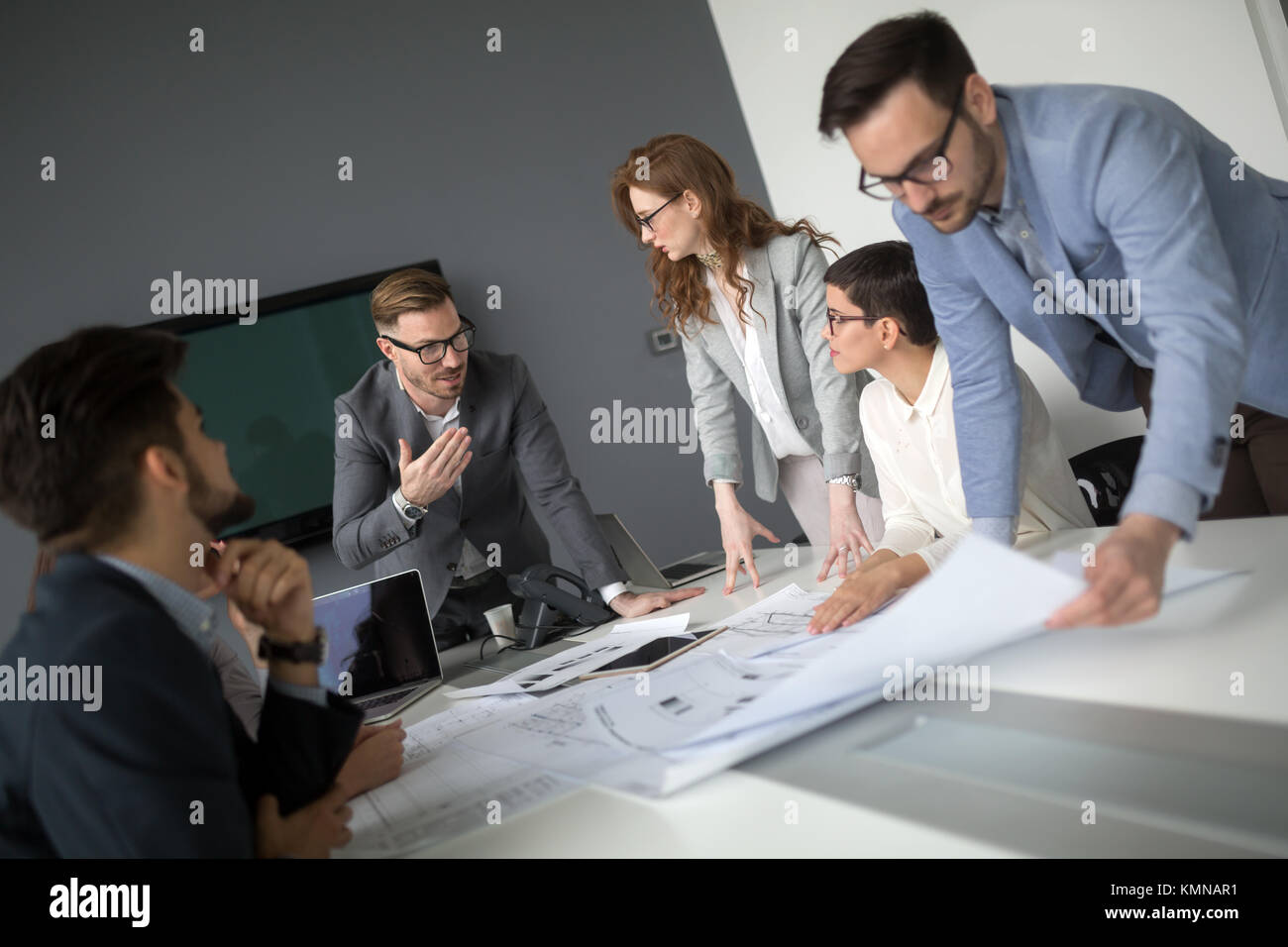 Group of business people collaborating in business office Stock Photo ...