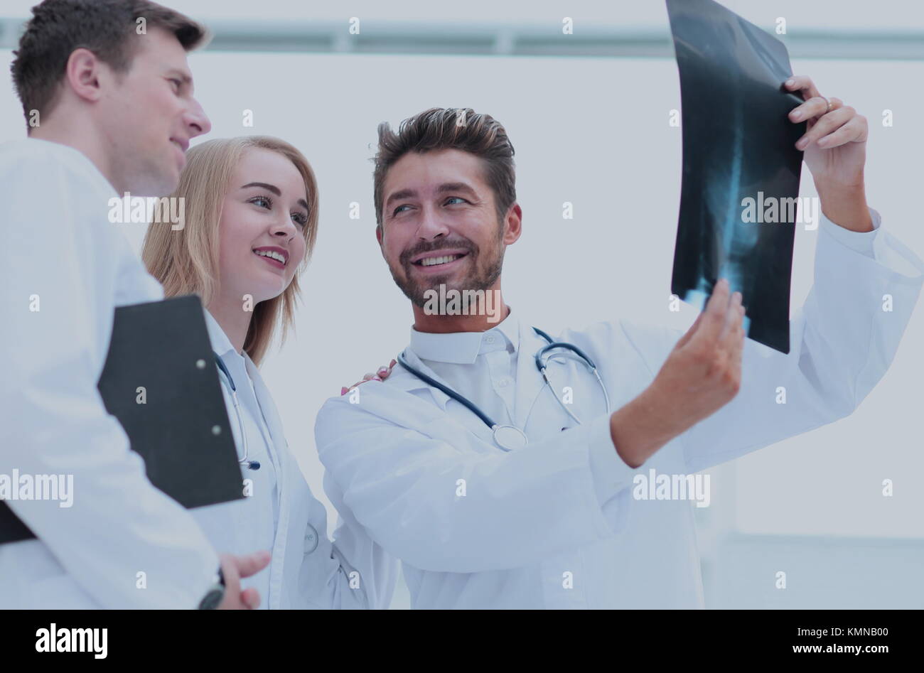 Handsome bearded doctor smiling confidently while discussing wit Stock ...