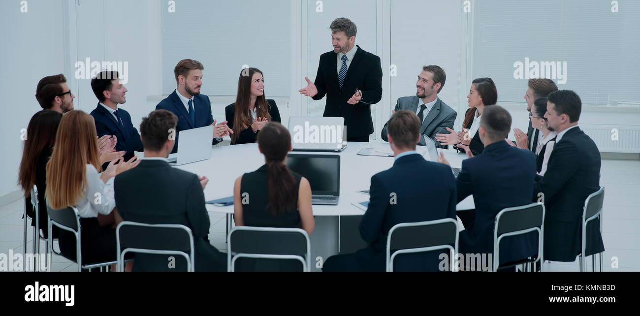 Business group greets leader with clapping and smiling Stock Photo - Alamy
