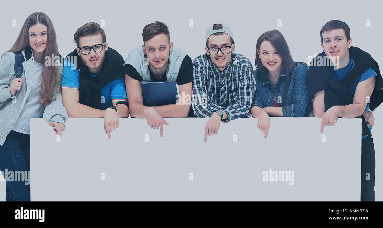 Full length portrait of confident college students displaying blank ...