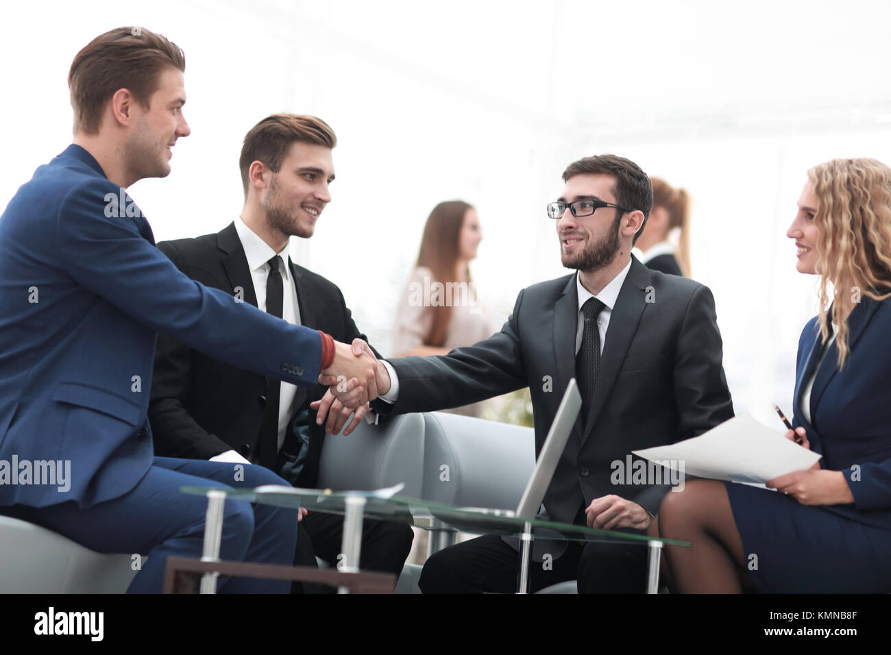 Partners concluding deal and shaking hands in the presence of team ...