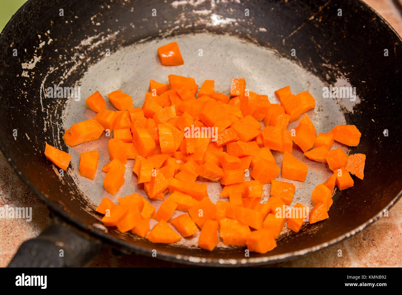 Close up chopped carrot in frying pan Stock Photo - Alamy