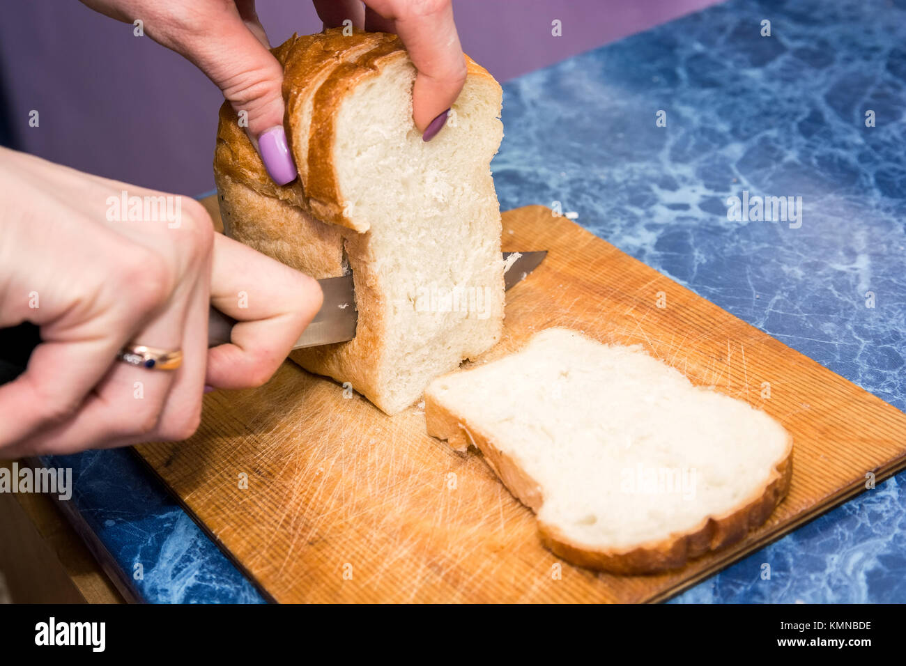 Female hands cut bread hi-res stock photography and images - Alamy