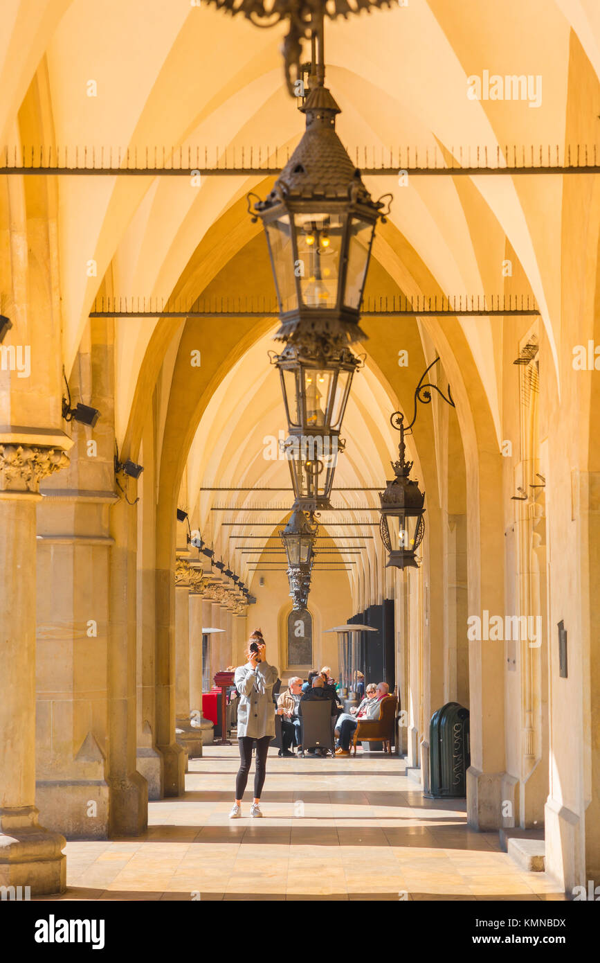 Krakow Cloth Hall, a woman tourist photographs the colonnade of the ...