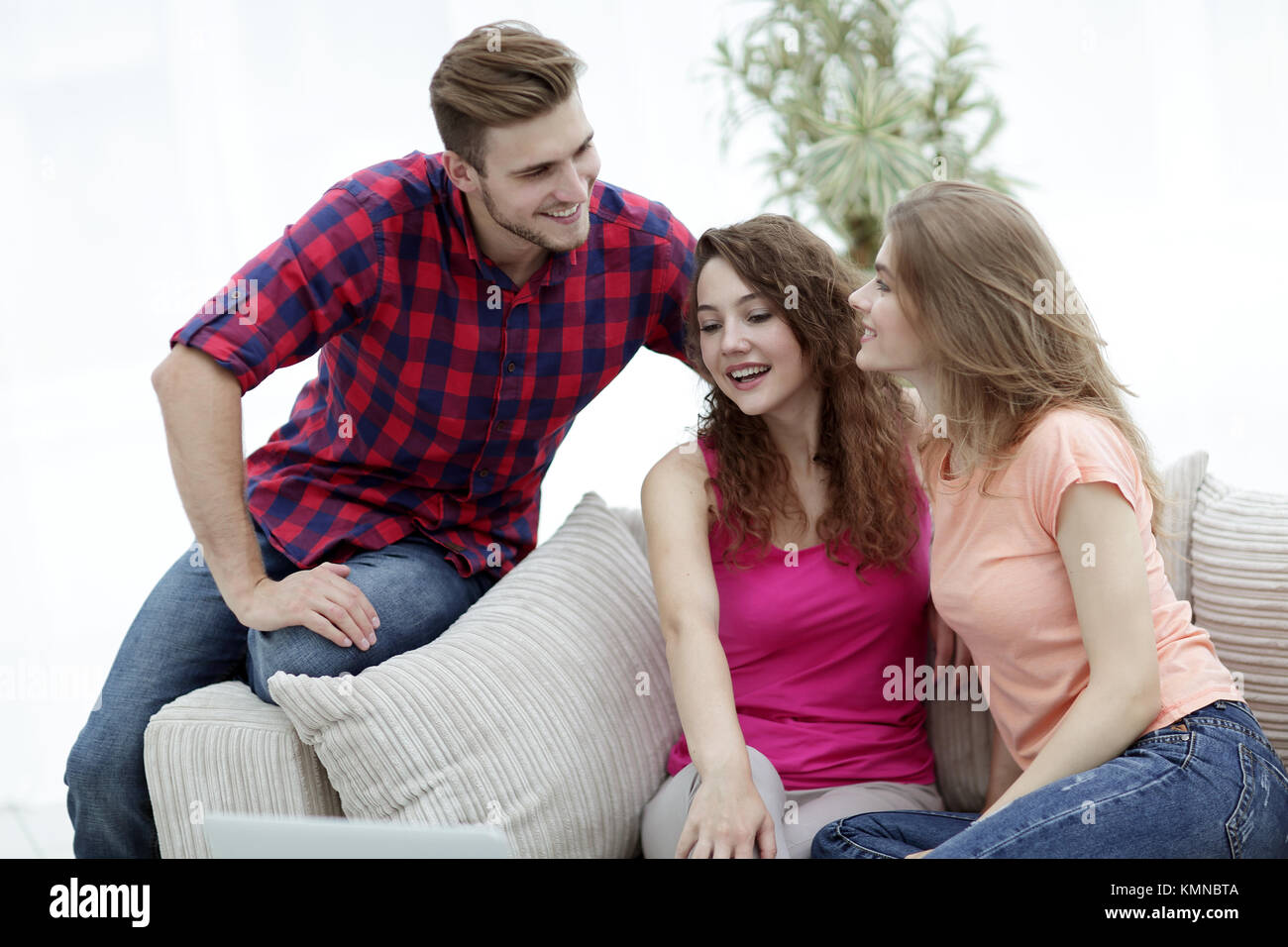 group of students sitting on the sofa in the living room Stock Photo ...