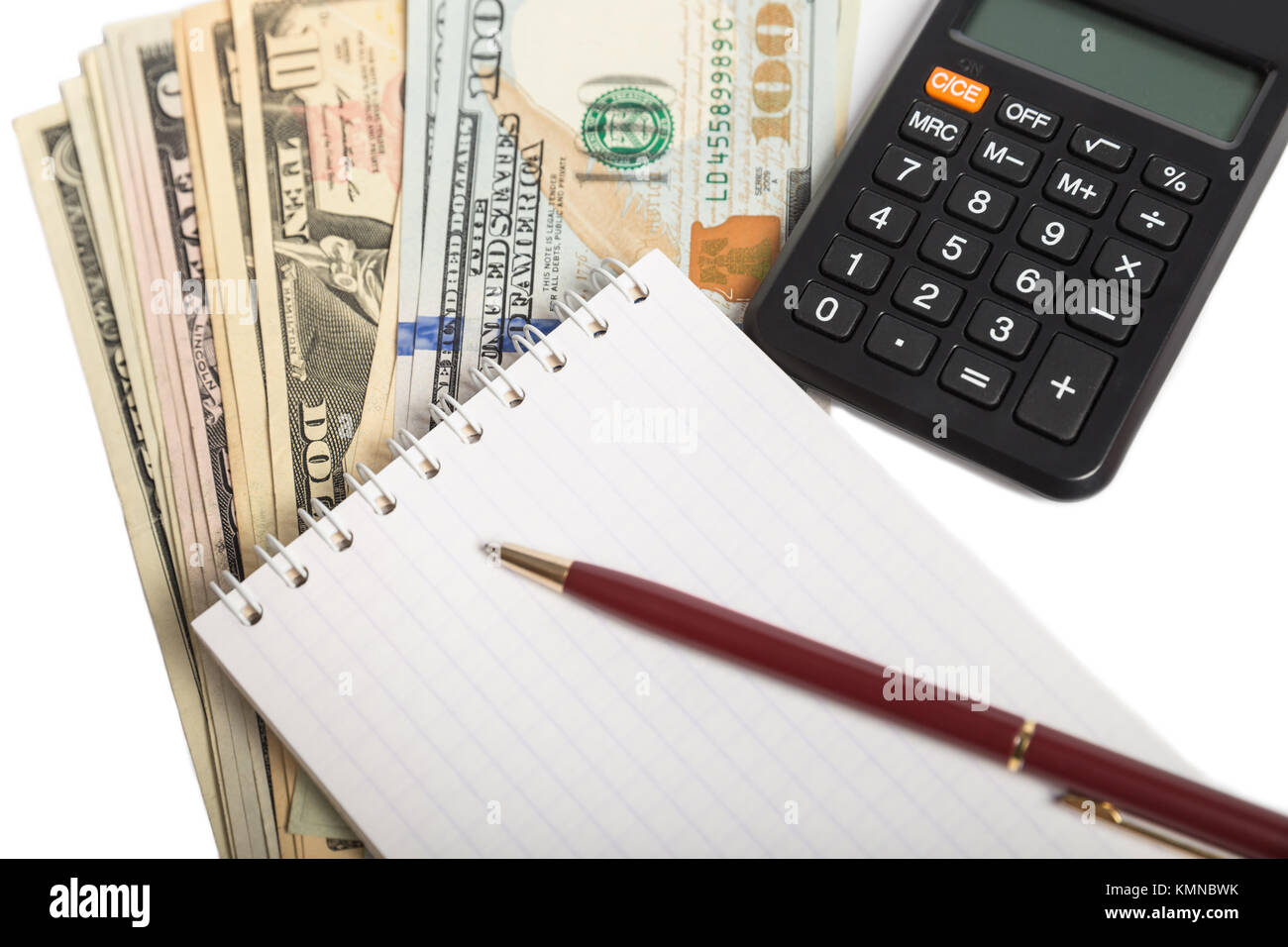 Notepad with blank sheet, pen, calculator and different dollar bills on ...