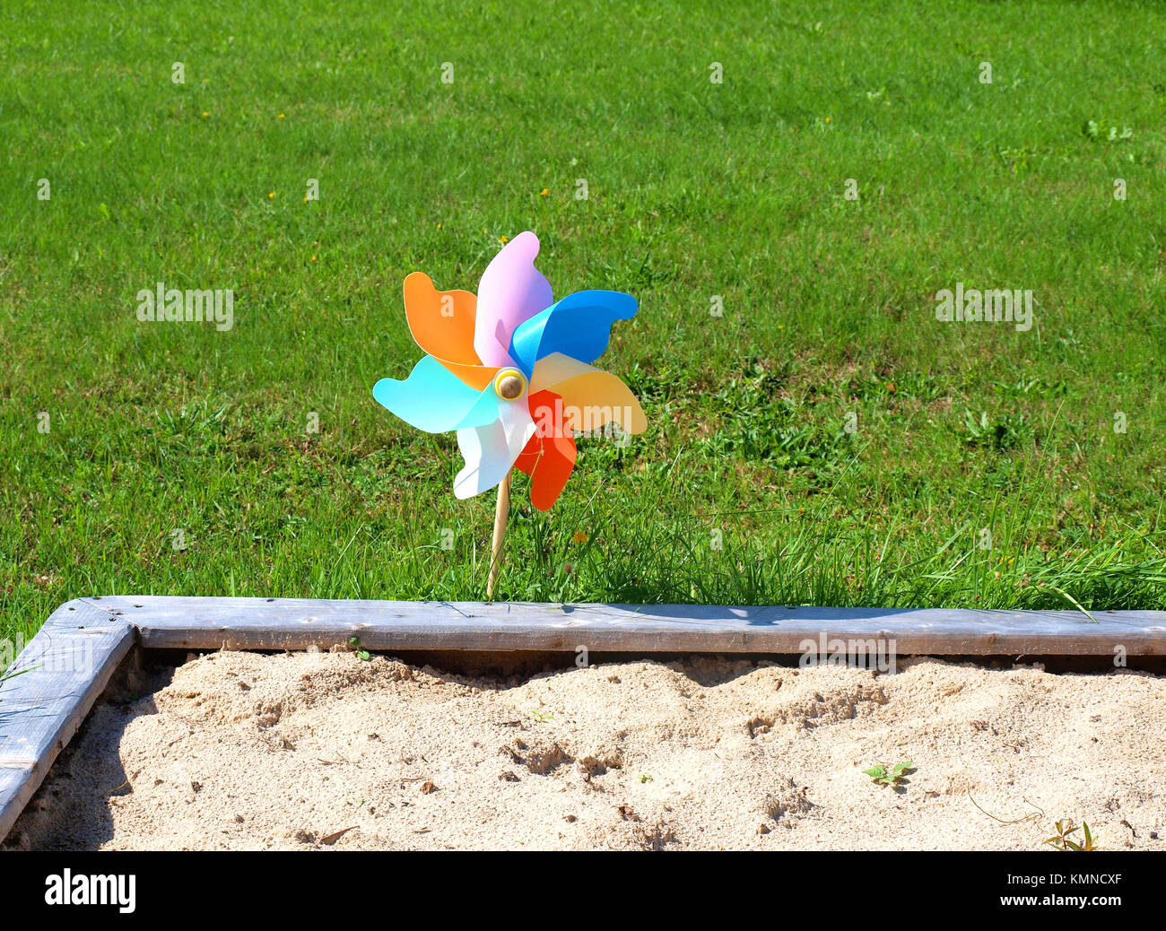 Homemade playground sand box with colorful toy windmill Stock Photo - Alamy