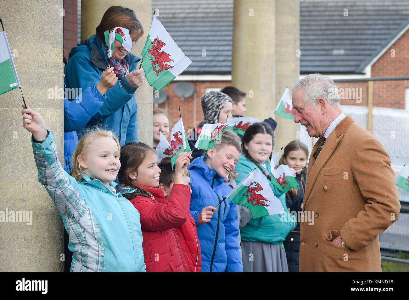 Children from St Cenydd and Cwm Rhymni schools wave Welsh flags as the ...