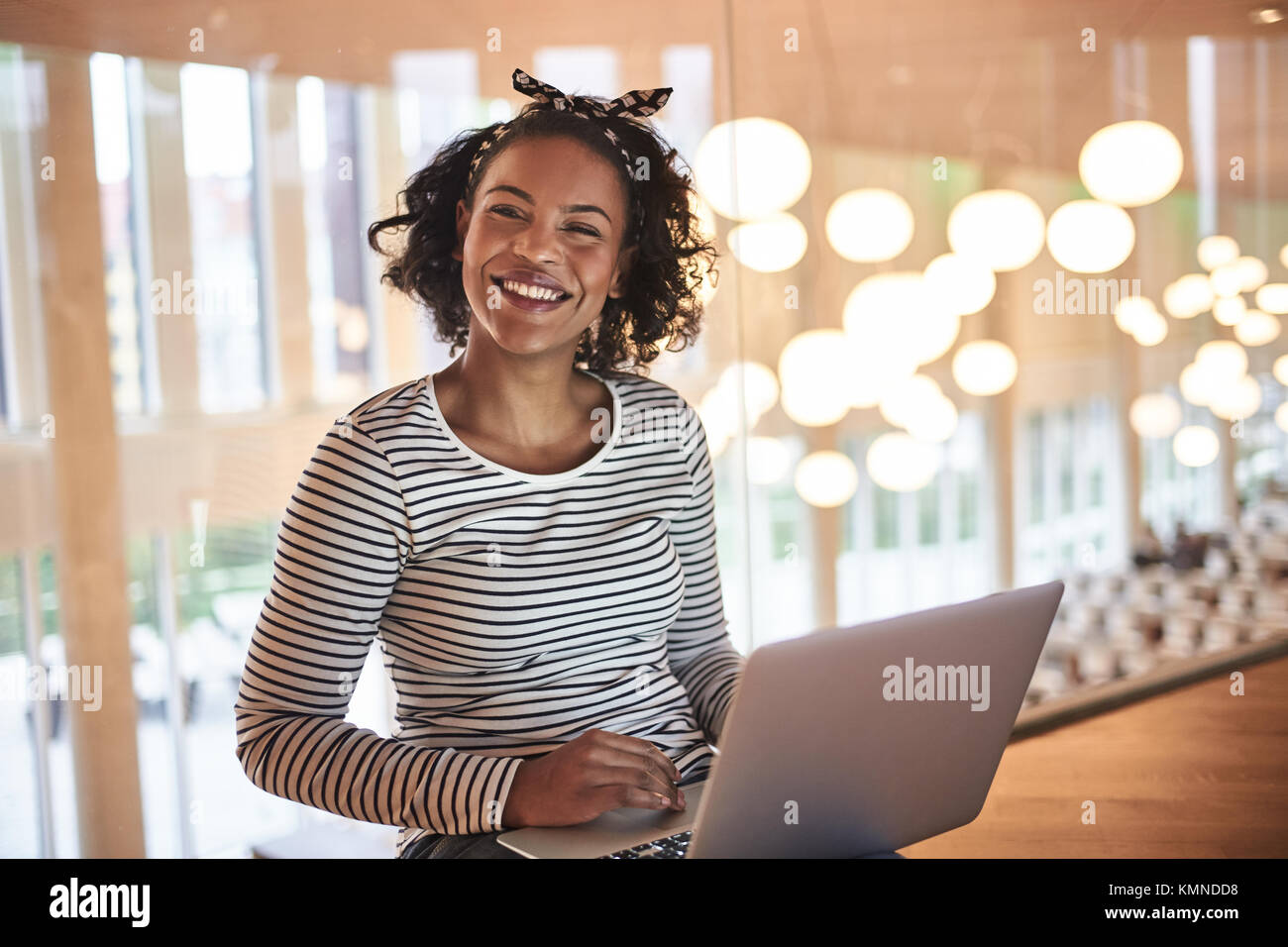 Young African college student smiling confidently while sitting alone ...