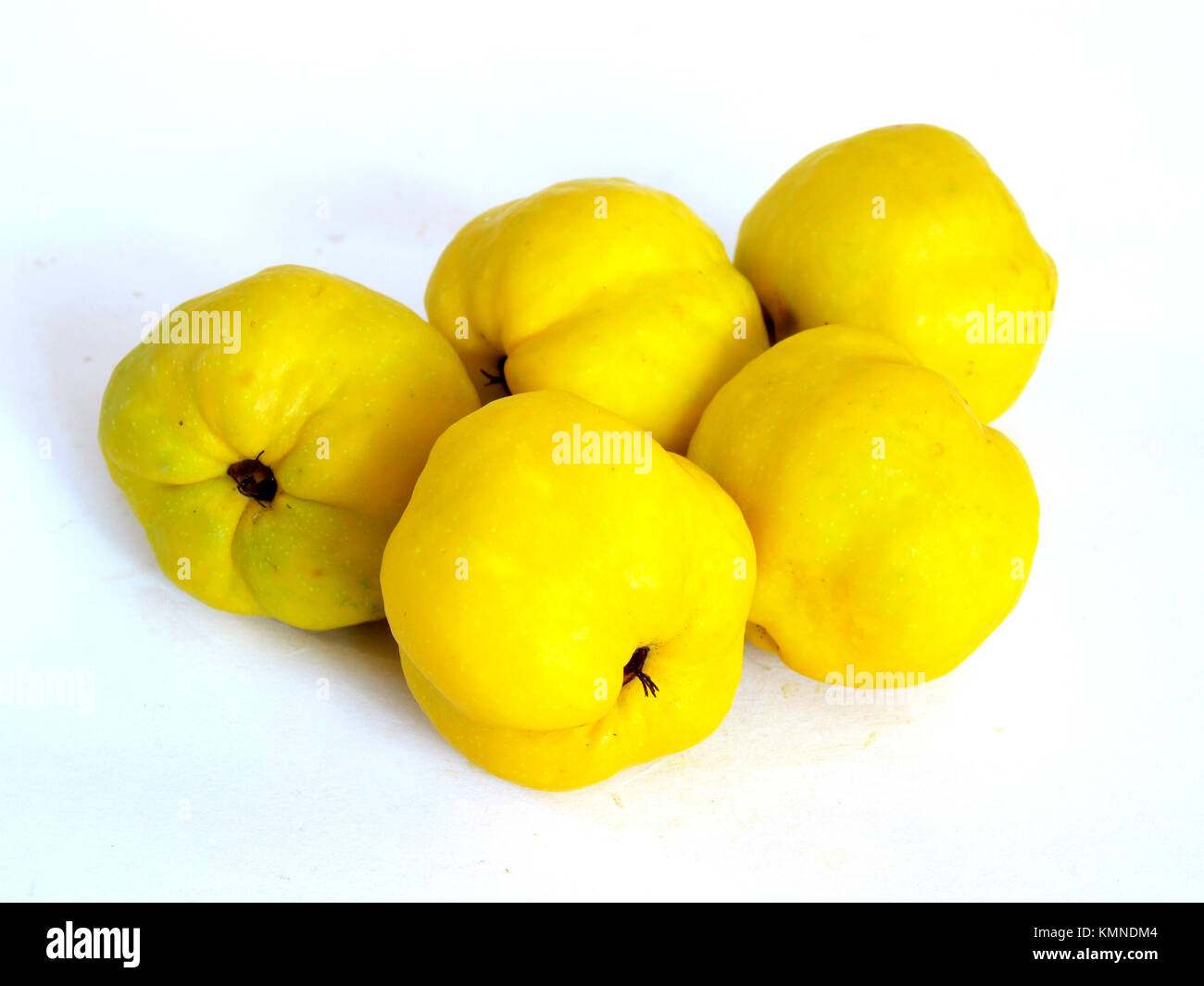 Ripe yellow quince fruits close up on white background Stock Photo - Alamy