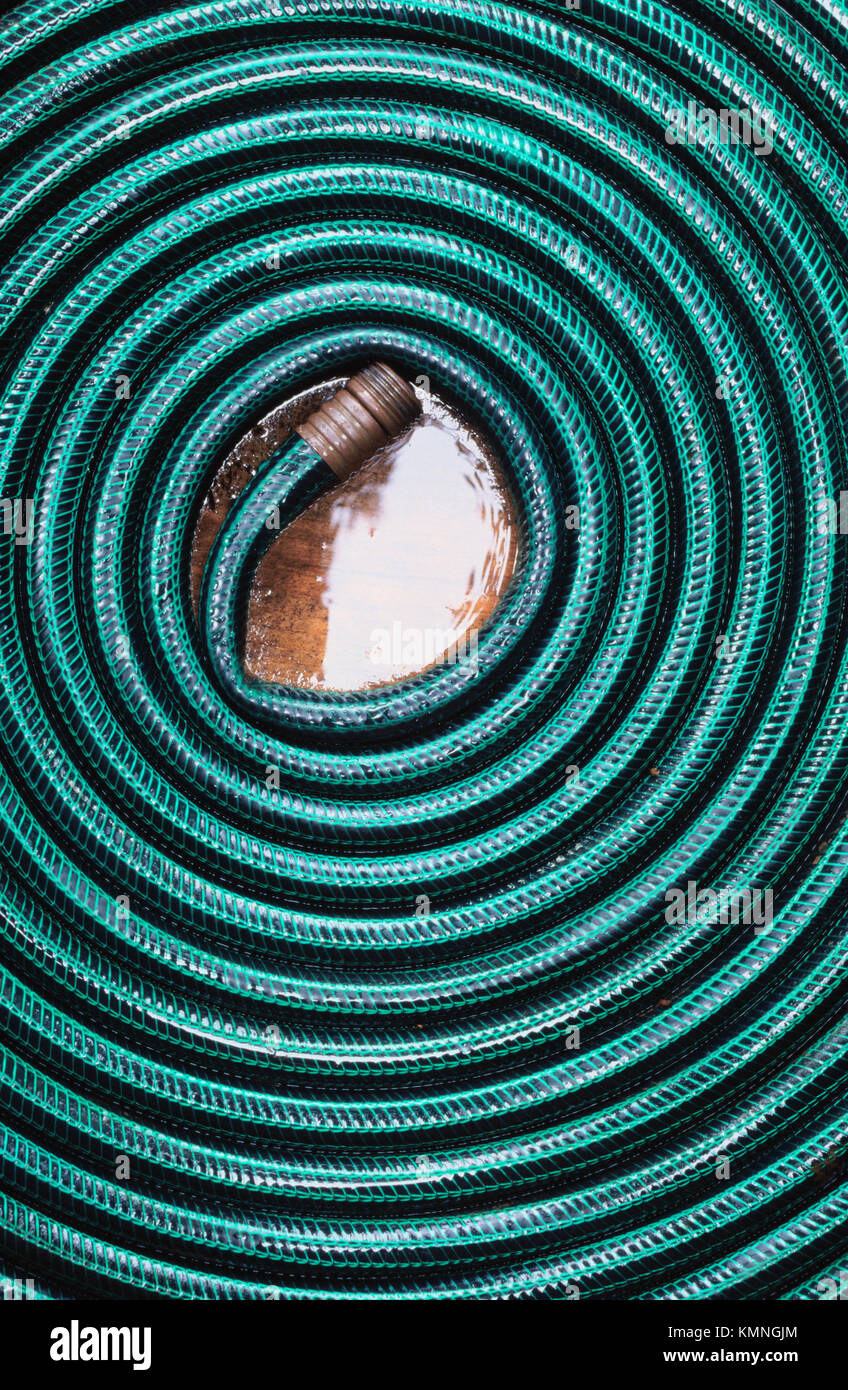 Coiled hose on ground Stock Photo - Alamy