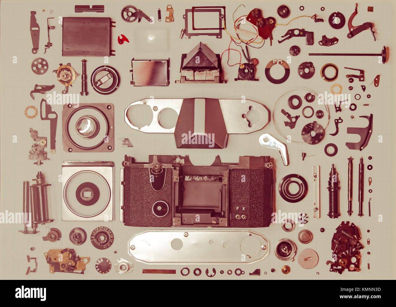 parts are completely disassembled old retro film SLR camera on graph ...