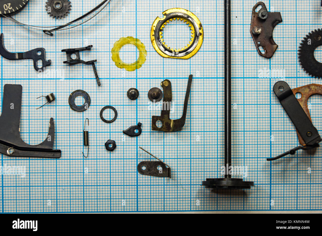 parts are completely disassembled old retro film SLR camera on graph ...
