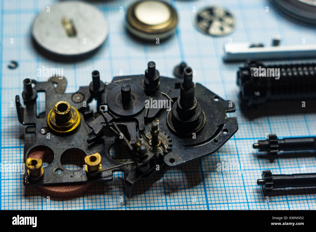 parts are completely disassembled old retro film SLR camera on graph ...