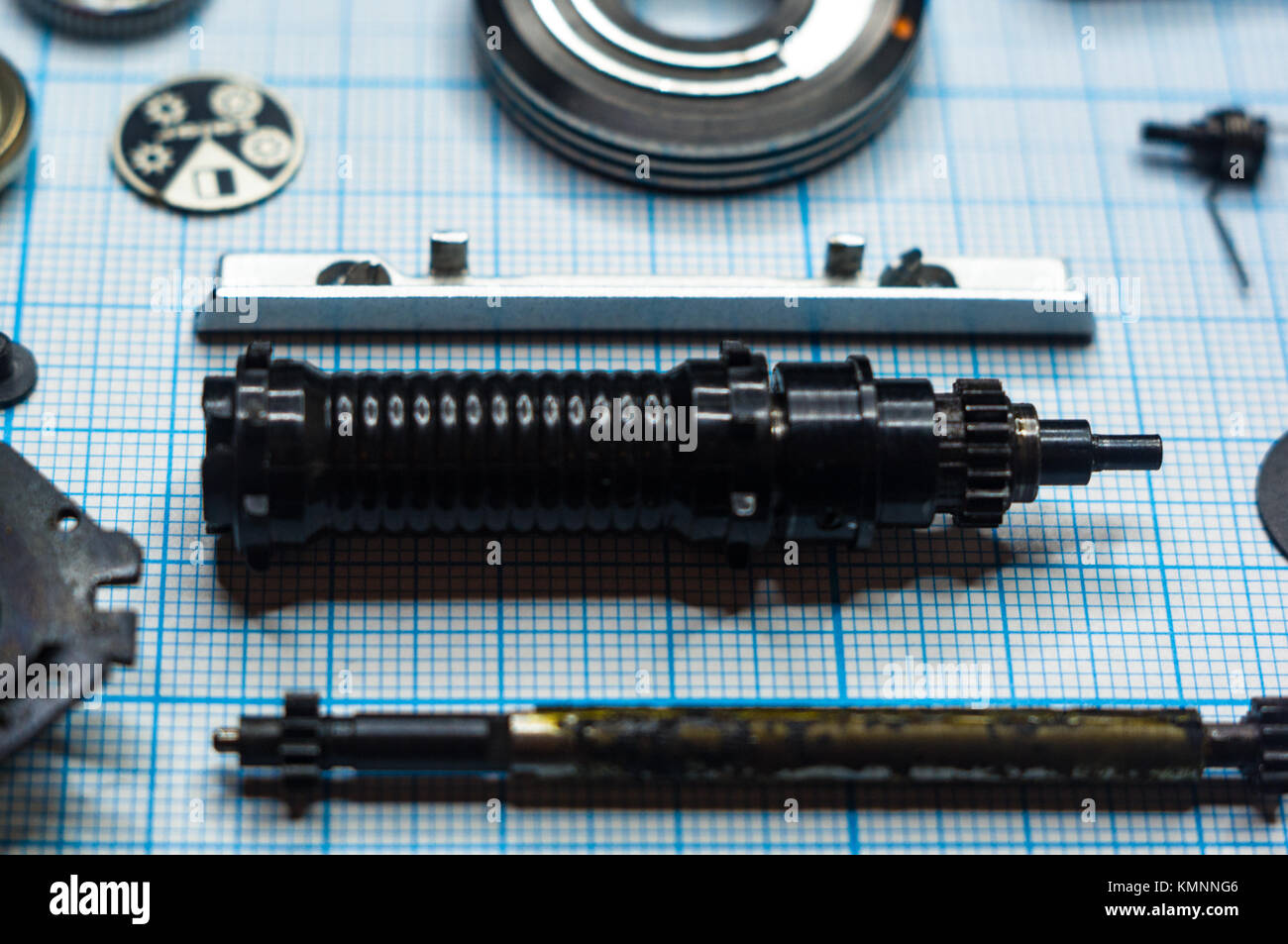 parts are completely disassembled old retro film SLR camera on graph ...
