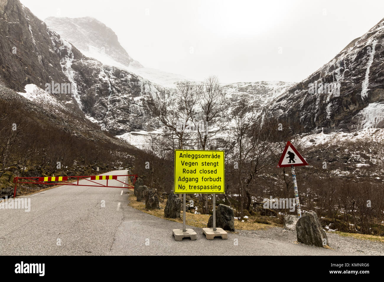 The start of the Trollstigen road, closed with a fence. A yellow sign ...