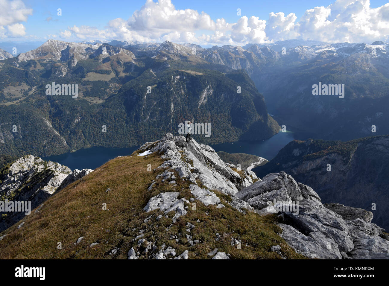 mountaineer takes pictures on Mt. Kleiner Watzmann towards lake ...