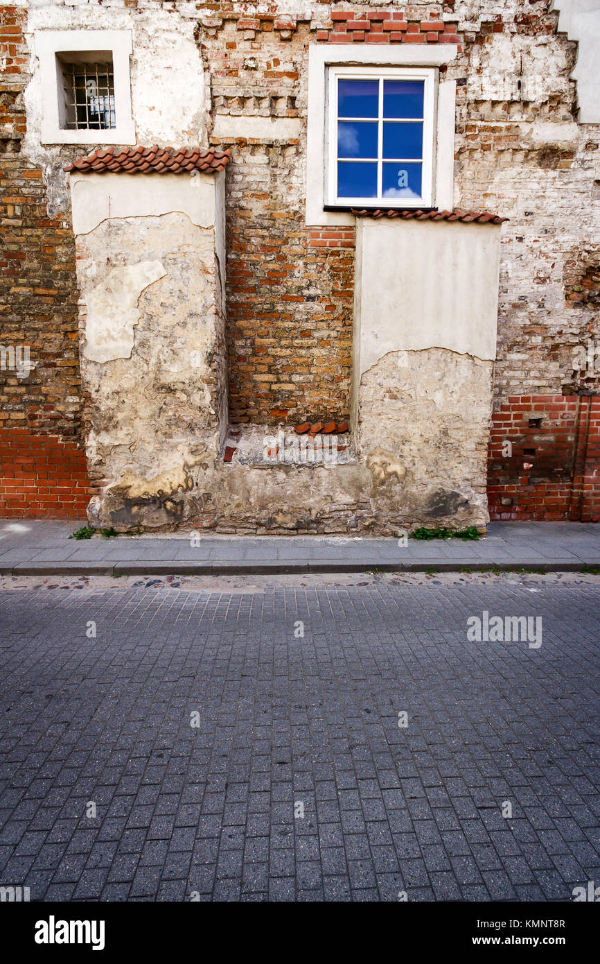 Aged weathered street wall with some windows Stock Photo - Alamy